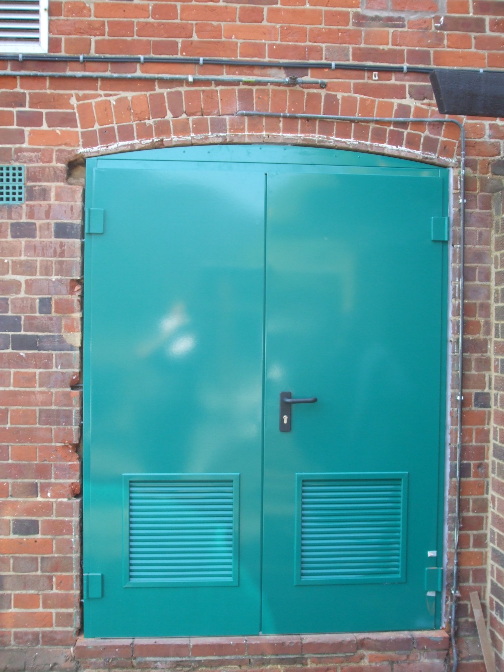 Steel Door Vision panels - powder coat and stainless steel.